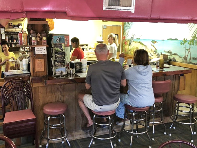 The counter seating offers front-row tickets to the breakfast show, where regulars exchange stories while waiting for their morning feast.