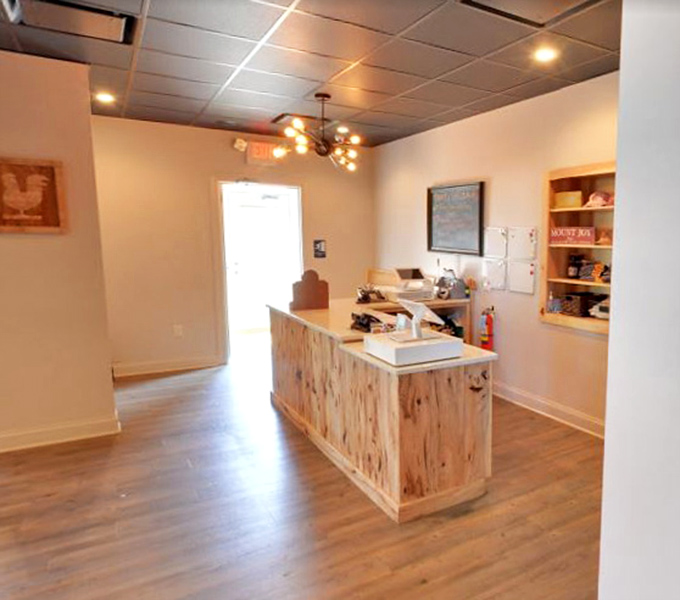 A reception area with rustic pine cabinetry that says, "Yes, we're serious about our barbecue, but we don't take ourselves too seriously."