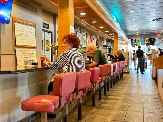 Classic diner booths in that unmistakable shade of pink vinyl—the color choice that somehow makes everything from pancakes to pot roast taste even better.