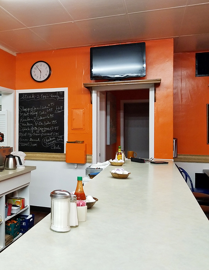 The counter where breakfast dreams come true. That chalkboard menu in the background holds the secrets to happiness, one special at a time.