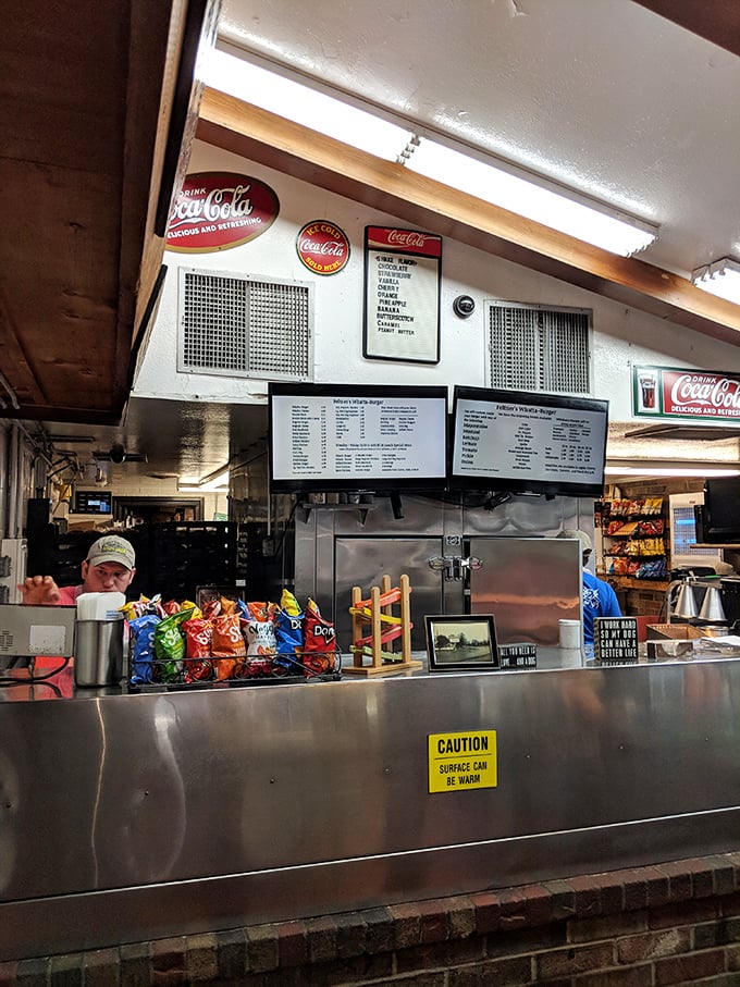 Where the magic happens &ndash; the grill area is all business, no pretense. That "Surface Can Be Warm" sign might be the understatement of the century.