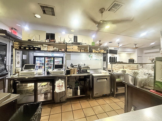 Behind the counter is where the magic happens – a well-orchestrated dance of cooks preparing Cuban classics with practiced precision.