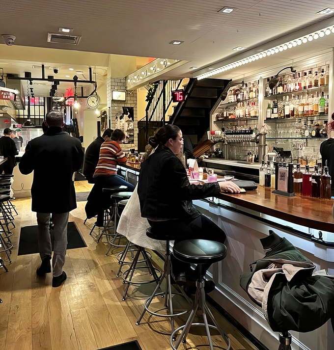 Where meat enthusiasts gather at the altar of flavor – the bar seating offers front-row views of mixology magic in action.