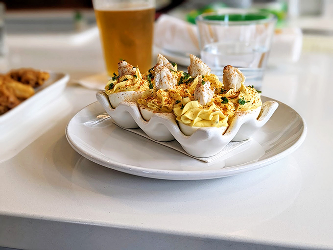 Deviled eggs elevated to art form. That seafood topping transforms a picnic classic into something worthy of coastal royalty.