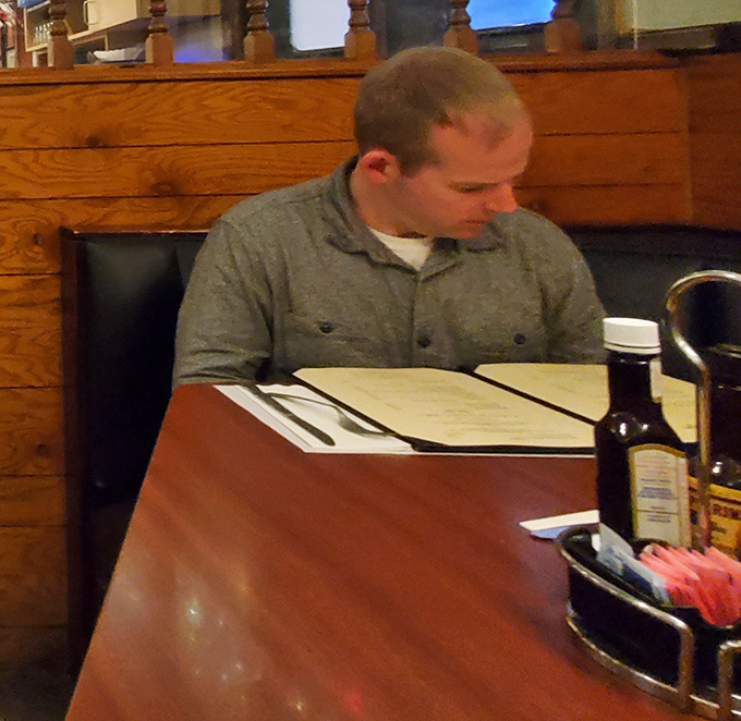 The contemplative diner studying the menu&mdash;we've all been there, facing life's most delicious dilemma: ribs or chicken?