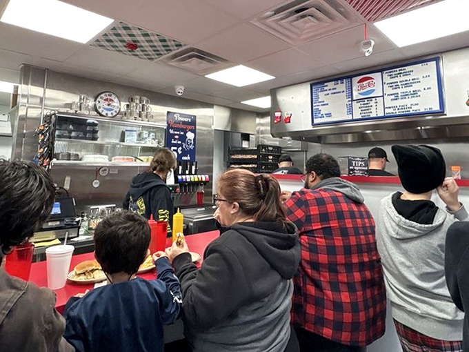 The true heart of Powers: customers of all ages gathered at the counter, united in their quest for burger perfection.