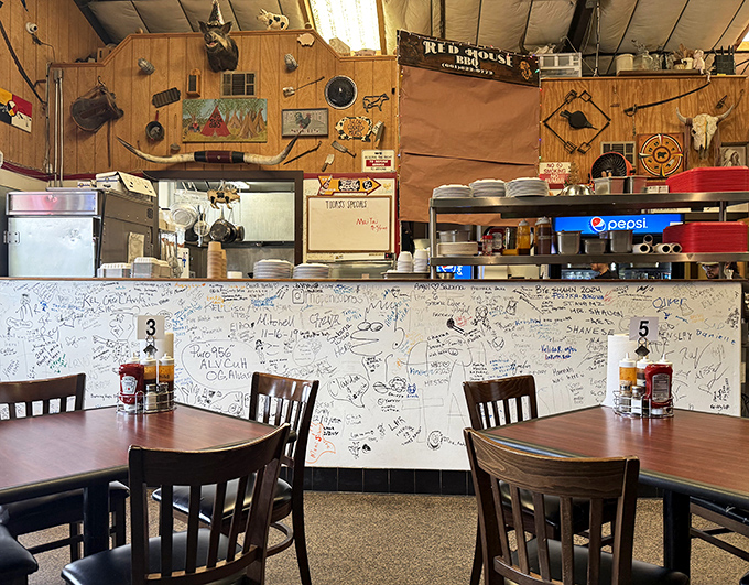 The counter where barbecue dreams come true, covered in the signatures of pilgrims who've made the journey before you.