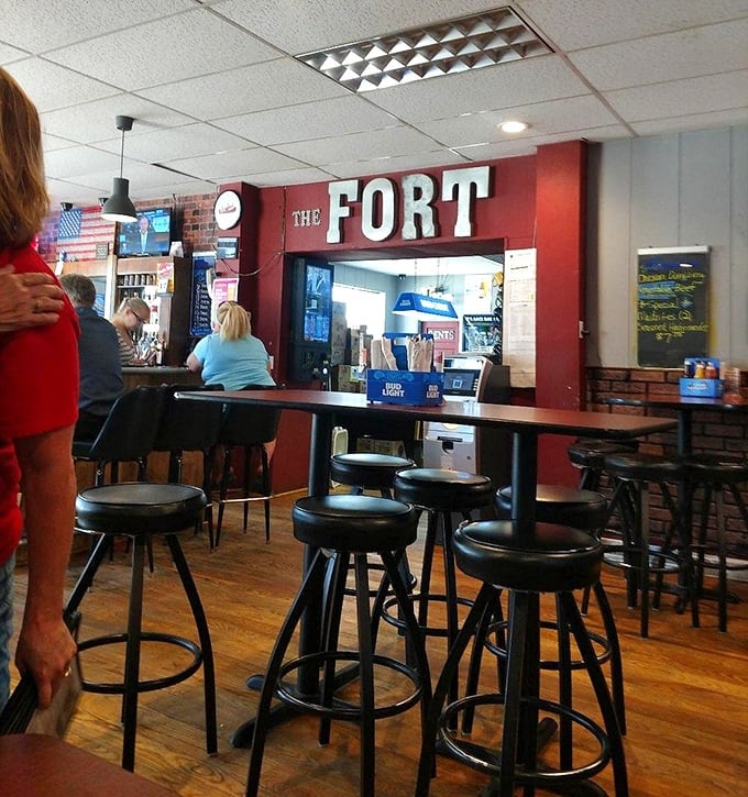 The Fort's sign glows like a beacon for hungry travelers, promising that inside these walls, calories don't count and everyone knows your name.