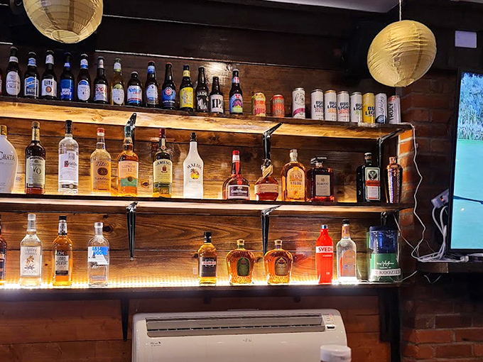 The bar shelves glow like an amber-hued library of liquid happiness, each bottle promising its own unique story by the glass.