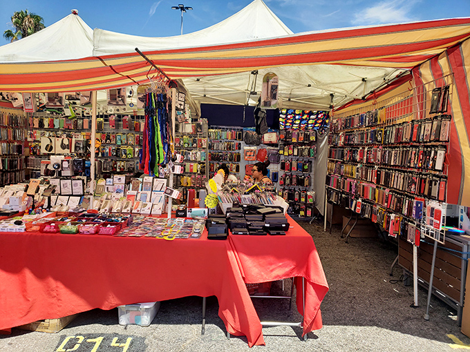 A tent of technological wonders. This red-tableclothed empire of phone cases and accessories proves the swap meet adapts to modern needs while keeping its vintage soul.