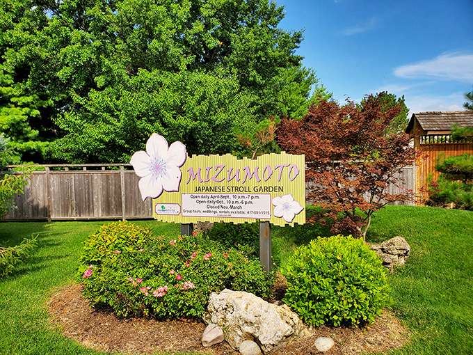 The garden's cheerful welcome sign promises seasonal delights year-round. Those cherry blossom illustrations aren't just pretty&mdash;they're a promise of spring spectacles to come.