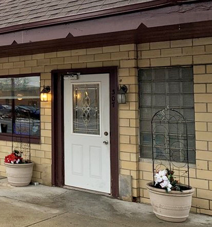 The entrance says "Welcome" without saying a word. Those flower pots aren't just decoration&mdash;they're a promise that someone here cares about the details.