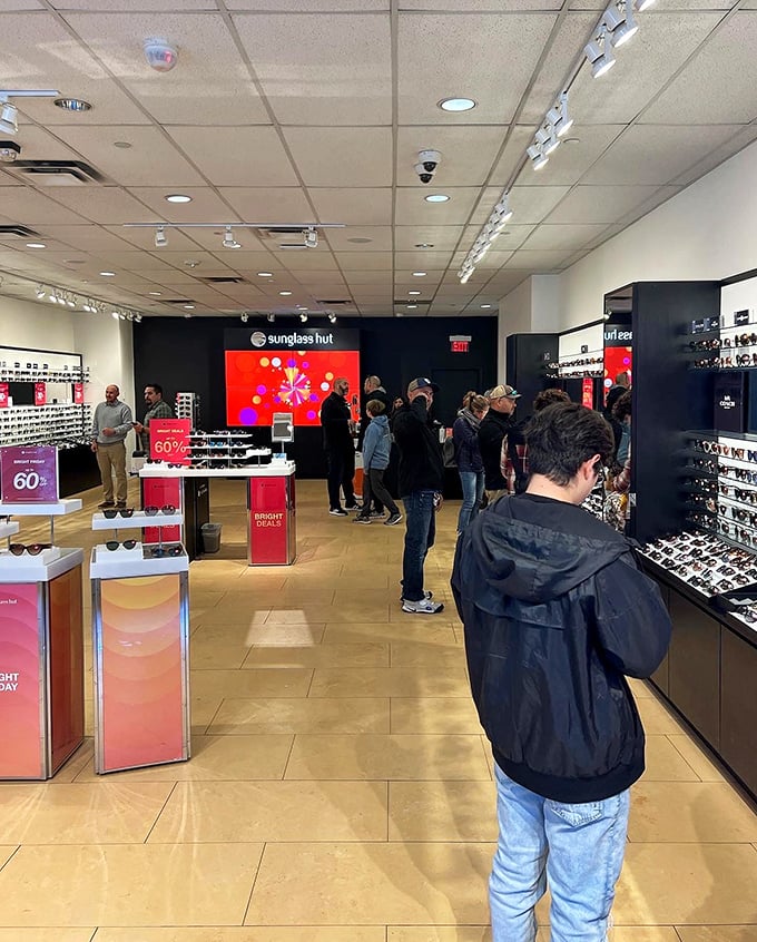 Sunglass Hut during peak season &ndash; where altitude-intensified sunshine makes those 60% off designer shades feel less like splurge, more like necessity.