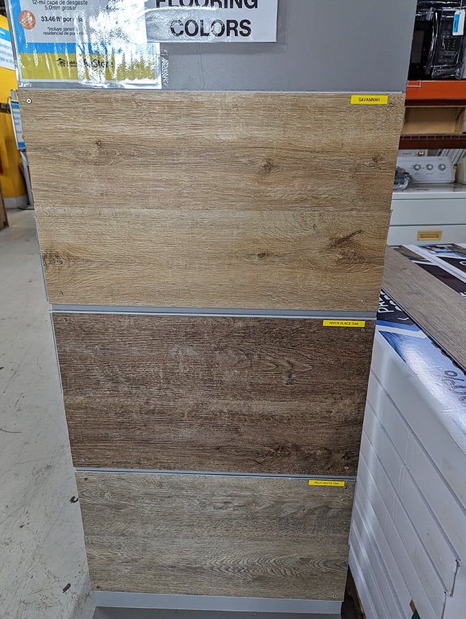 Flooring samples arranged like paint swatches for your feet. Three shades of "looks-like-real-wood" that won't empty your retirement fund.
