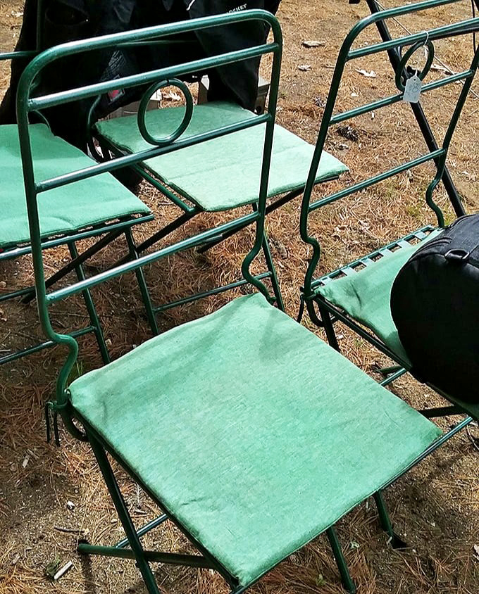 These mint-green folding chairs aren't just seating – they're 1950s functional art waiting to grace someone's porch or vintage-themed garden party.