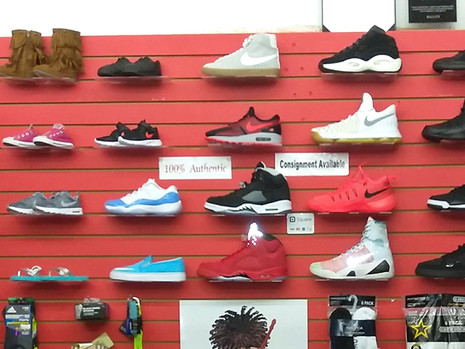 Sneakerhead nirvana on a bright red wall. The "100% Authentic" sign is the cherry on top of this footwear feast.