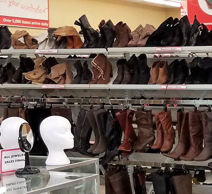 Boot boulevard, where leather dreams line up for second chances. That mannequin head silently judges your footwear choices.
