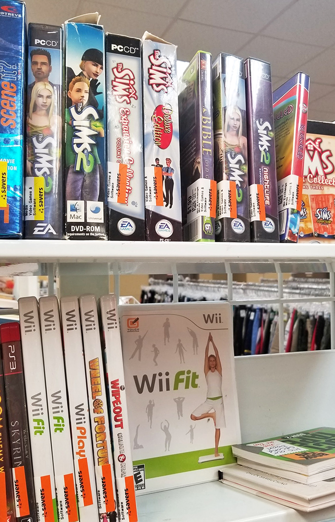 Video game history displayed on a shelf—from The Sims to Wii Fit—proving one generation's obsolete technology is another's nostalgic treasure.
