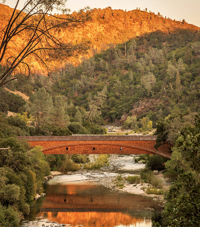 At golden hour, the bridge's reflection dances on the river's surface, creating a double dose of history bathed in nature's perfect lighting.