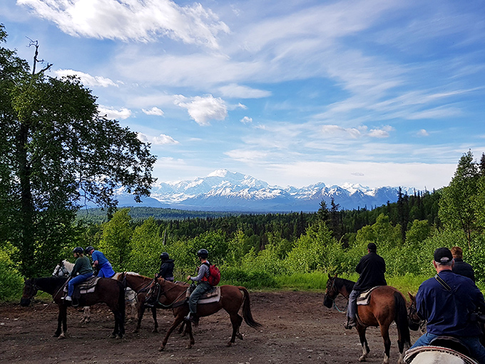 Horseback riders pause to absorb Denali's majesty, proving some viewpoints are best earned the old-fashioned way&mdash;one hoof-beat at a time.