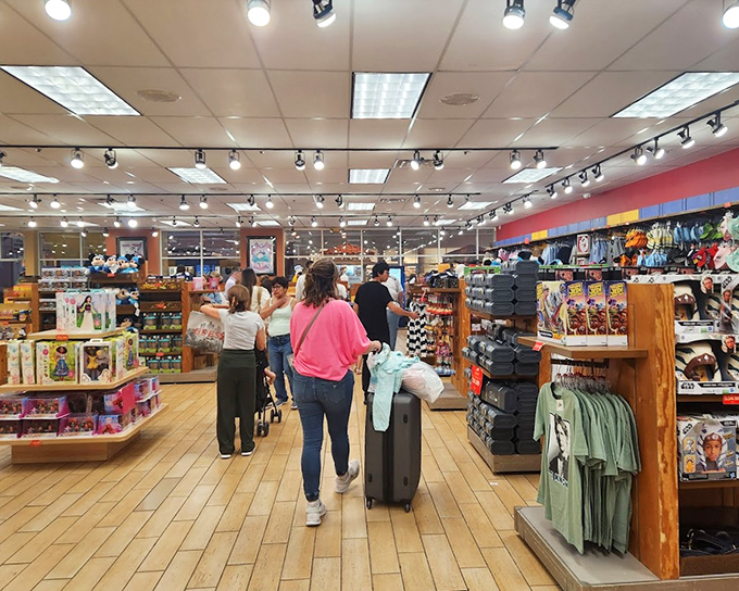 Tourists navigate a sea of souvenirs, proving that "I went to Florida and all I got was this t-shirt" remains an eternal travel tradition.