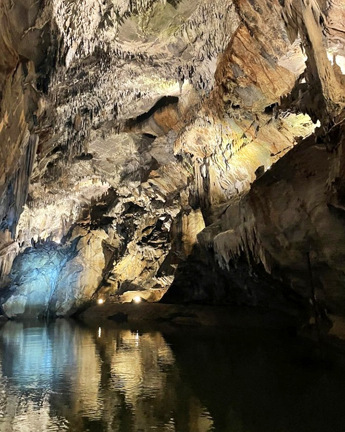Cathedral ceilings that took millions of years to perfect. Inside Penn's Cave, stalactites hang like nature's chandeliers over the glassy water below.