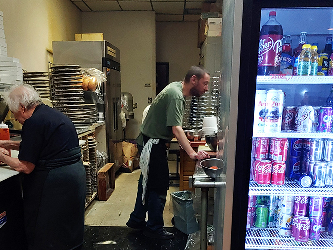 Behind the scenes, the kitchen crew orchestrates the pizza magic with practiced hands and zero pretension&mdash;food made with care, not for cameras.
