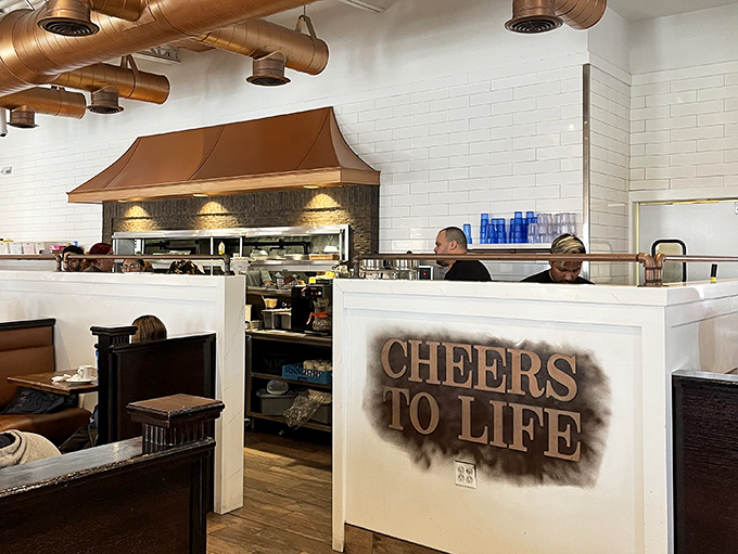 "CHEERS TO LIFE" isn't just wall decor&mdash;it's the philosophy behind every plate that emerges from this open kitchen. Breakfast as celebration, not just sustenance.