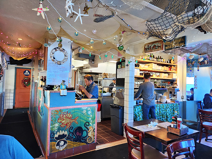 The kitchen where fresh seafood transforms into edible magic &ndash; notice the organized chaos that feeds the hungry masses outside.