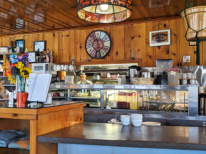 The open kitchen view lets you watch breakfast magic happen while a vintage clock reminds you time stops here.