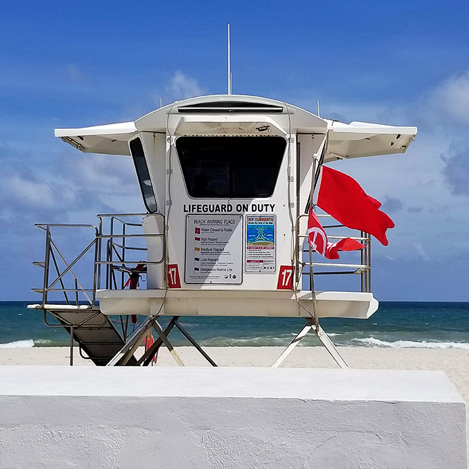 Lifeguard Station 17 stands ready, a white sentinel against azure waters where Baywatch dreams and beach reality meet.