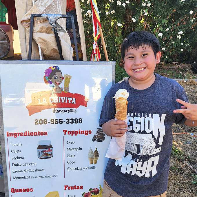 A young customer proudly displays his marquesita treat, the rolled wafer cone filled with sweet ingredients&mdash;fuel for the next round of shopping.