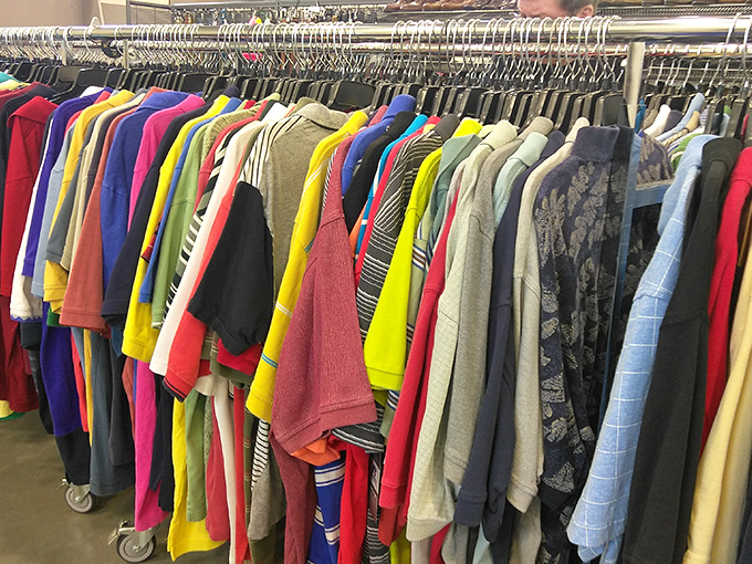 A kaleidoscope of men's shirts hanging like colorful flags of fashion opportunity. That pink blazer is calling someone's name!