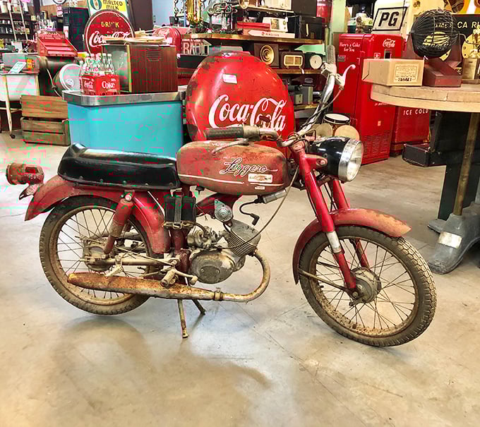 A vintage motorcycle wearing Coca-Cola red – when two-wheeled freedom came with a kickstart and real chrome.
