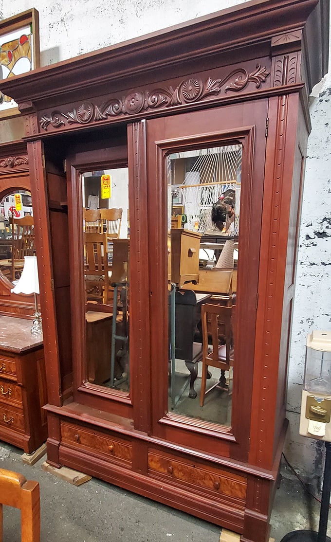 This isn't just a wardrobe; it's a portal to another era when craftsmanship meant hand-carved details and mirror-perfect reflections.
