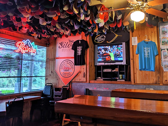 Beer signs glow like stained glass windows in this cathedral of comfort food, where neon and nostalgia create the perfect dining atmosphere.