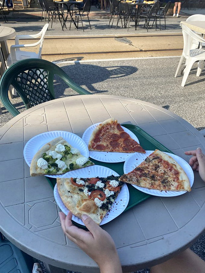 Al fresco dining, Little Anthony's style. Four different slices on paper plates&mdash;this is what pizza researchers call "the perfect experiment."