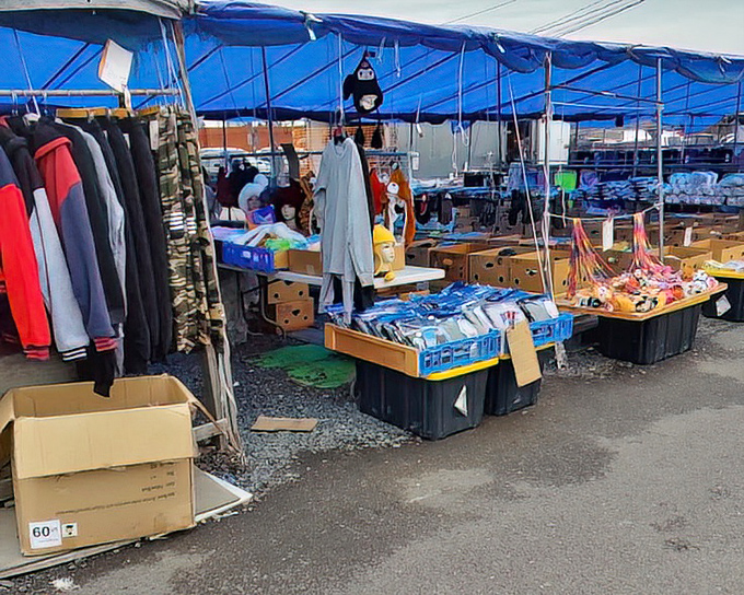 Under blue tents, vendors arrange their wares like modern-day merchants from a bygone bazaar.