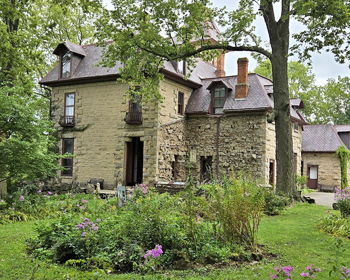 The castle's exterior blooms with colorful gardens. Nature and architecture performing a perfect duet that's been running for over a century.