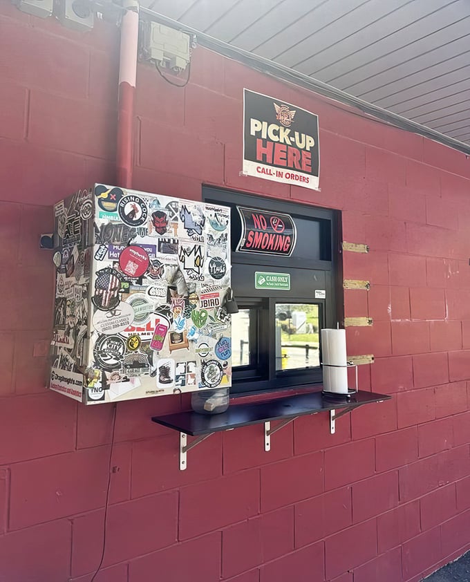 The pickup window, decorated with years of stickers from loyal fans, is like a passport stamped with memories of Charlotte's food culture.