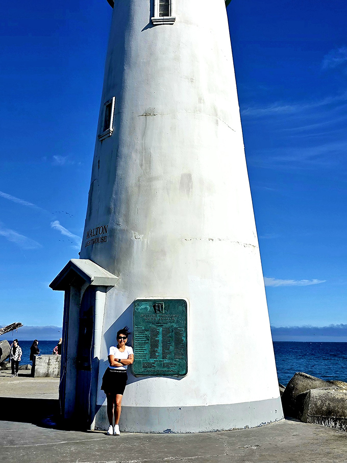 The lighthouse keeps watch while visitors snap memories. Some landmarks are generous enough to pose for every camera.