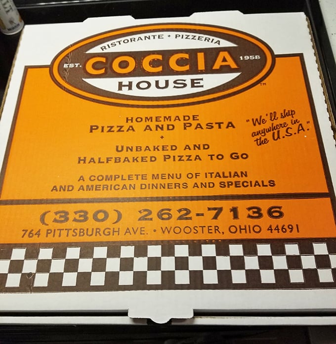 The iconic orange pizza box promising homemade goodness. "We'll ship anywhere in the U.S.A." is the kind of confidence that comes from knowing your pizza rocks.