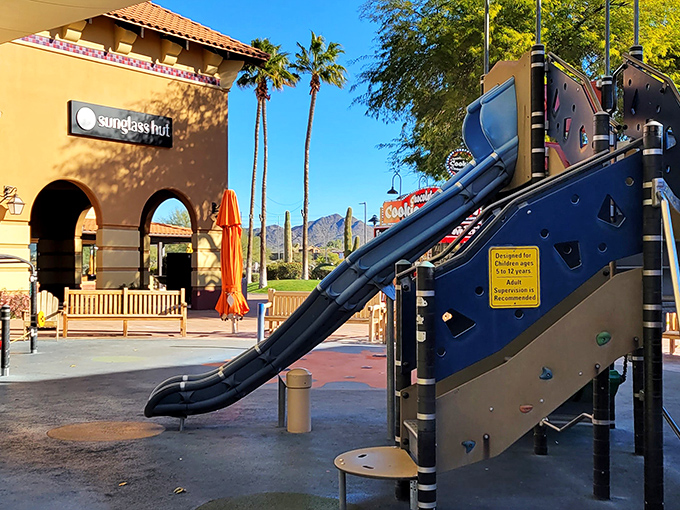A playground oasis with Sunglass Hut in the background &ndash; because parents deserve shade while kids burn energy.