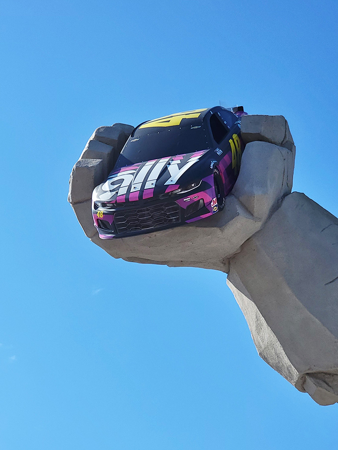 That's not a toy car&mdash;it's a full-sized NASCAR vehicle in Miles' mighty grip, making this the world's most intimidating hood ornament.