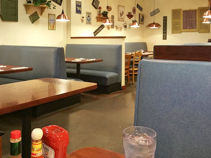 Blue booths and wooden chairs create that "stay awhile" vibe. The kind of place where coffee refills and conversations flow freely.