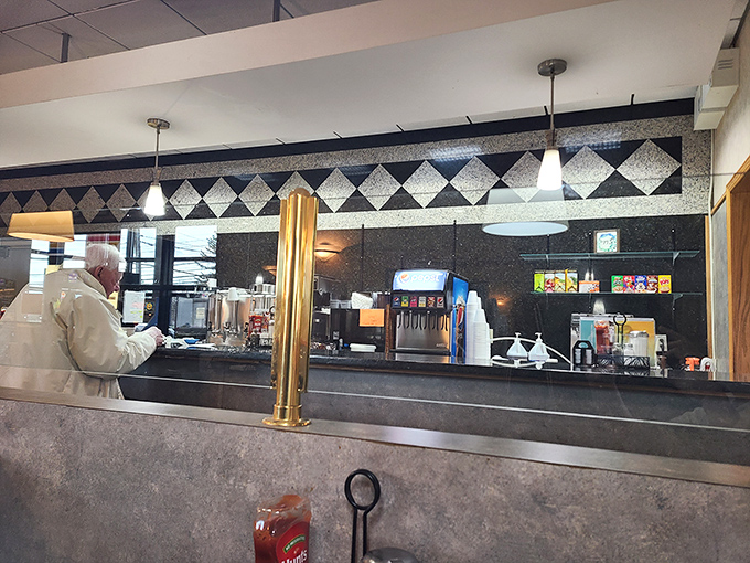 The beating heart of any great diner—a service counter where breakfast dreams become reality. Coffee machines stand at attention, ready for duty.