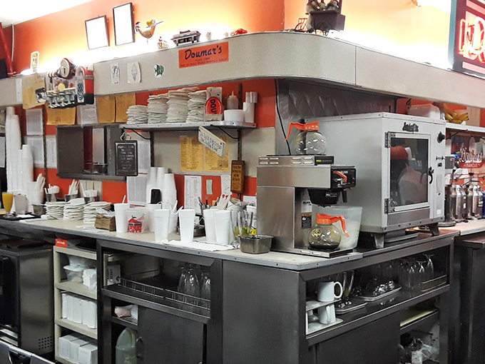 Behind the counter, the organized chaos of a well-oiled diner kitchen promises that your comfort food will arrive with the efficiency of a NASCAR pit crew.