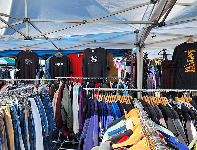 Vintage clothing heaven under white canopies. Those t-shirts have seen more concerts than your Spotify playlist ever will.