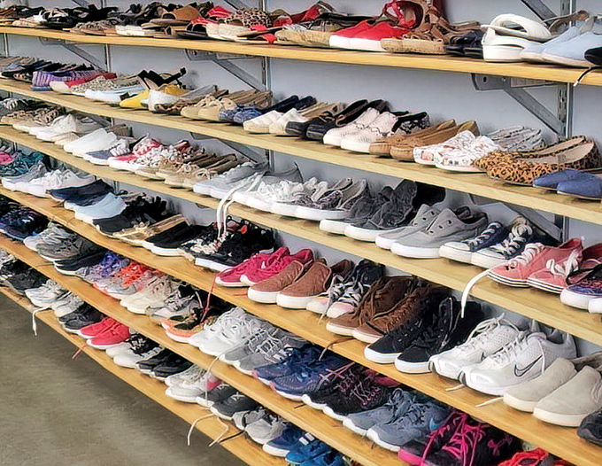 Shelf after shelf of shoes in every style imaginable, organized like a footwear library waiting to be explored.