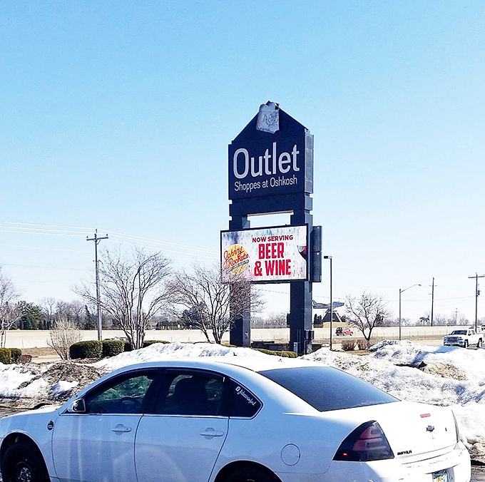 The beacon of bargains! This sign not only guides you to savings but also advertises beer and wine&mdash;because shopping is thirsty work.